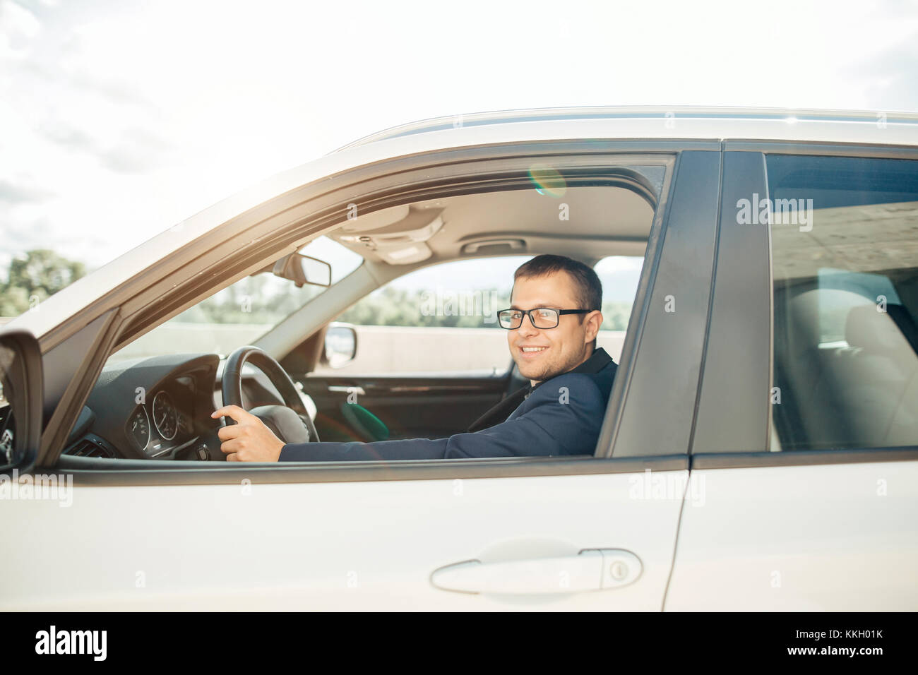 Handsome elegant serious man drives a car Stock Photo - Alamy