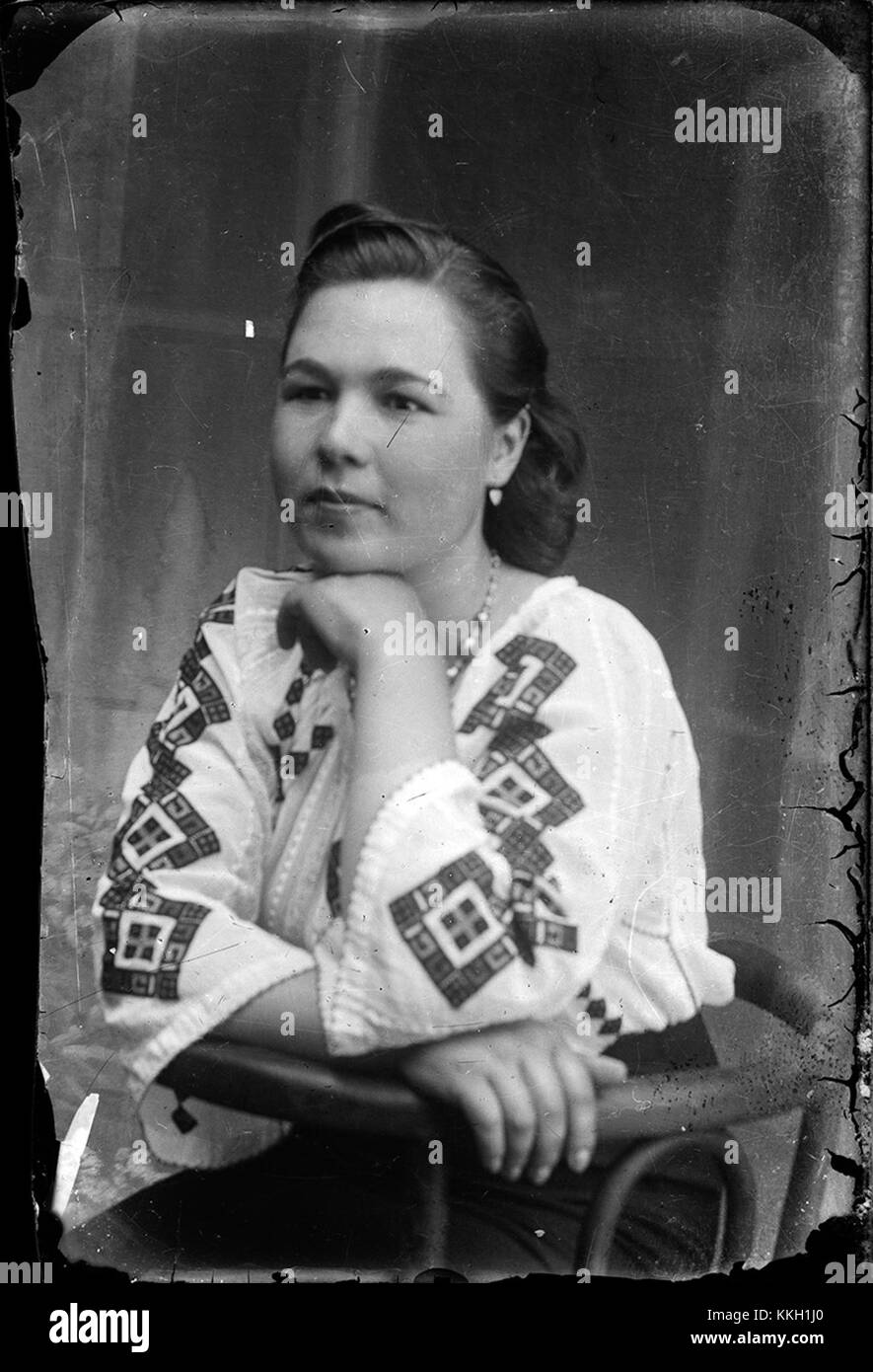 This image features a woman dressed in traditional Romanian folk attire ...