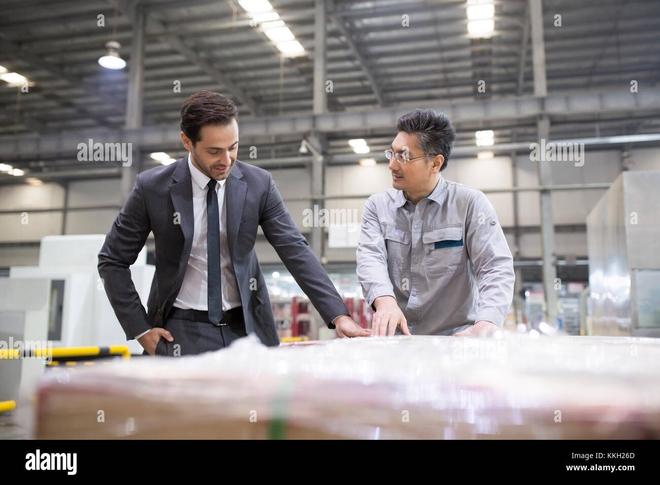 Businessman and engineer talking in the factory Stock Photo - Alamy