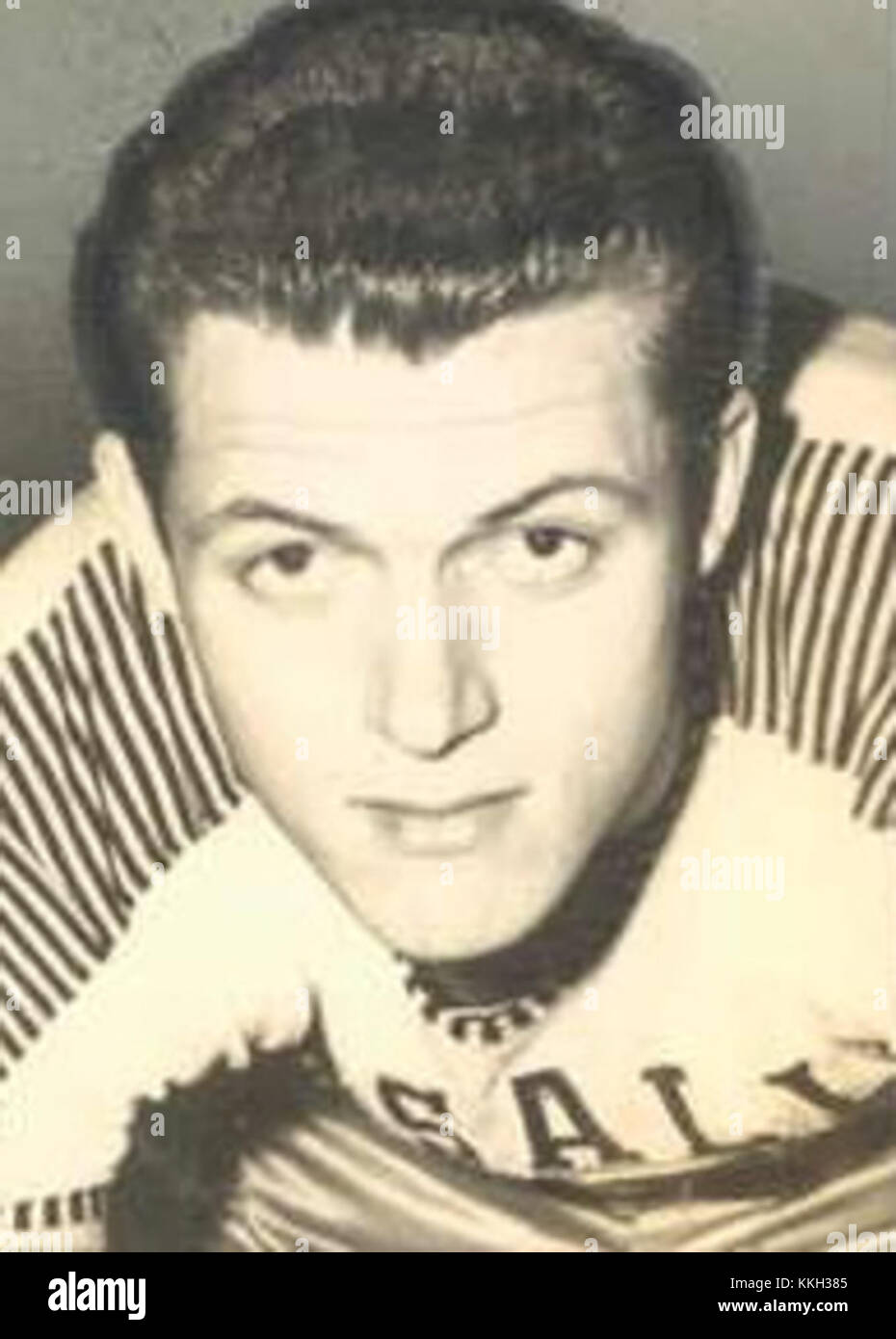 This image features Tom Gola, a renowned basketball player from the ...