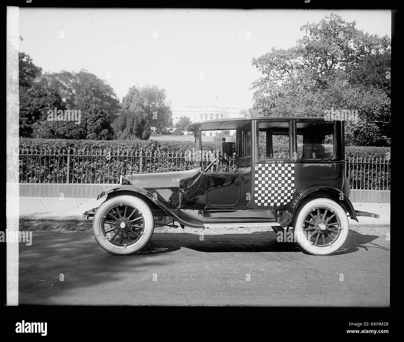 This image features a checkered cab with the White House in the ...