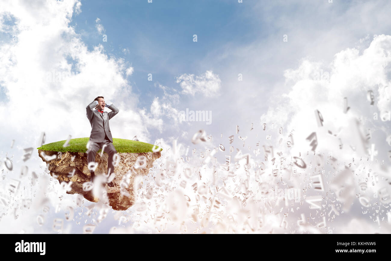 Young man floating in sky and dont want to hear anything Stock Photo ...