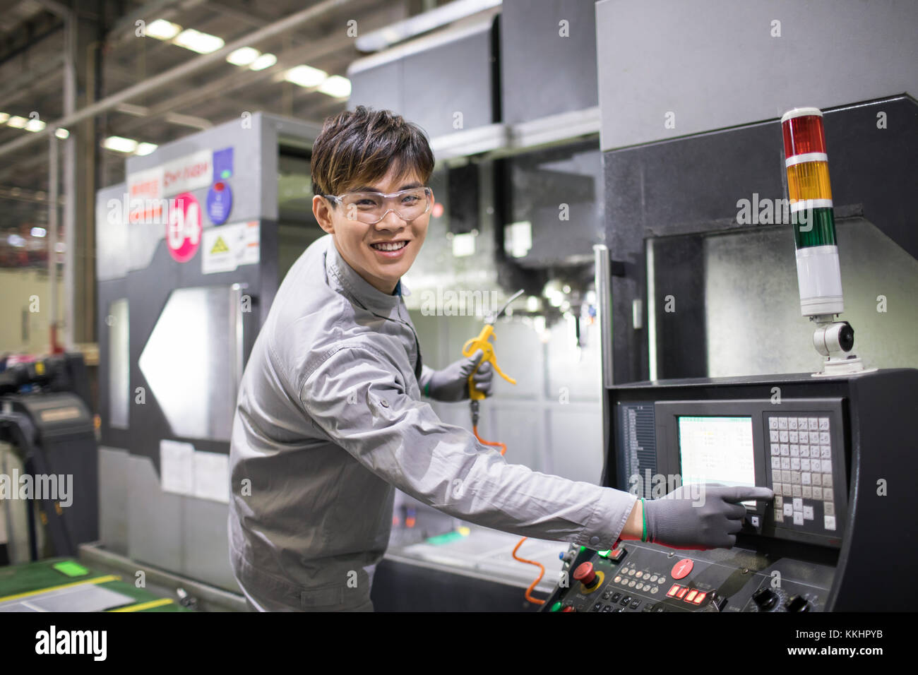 Confident Chinese engineer working in the factory Stock Photo - Alamy