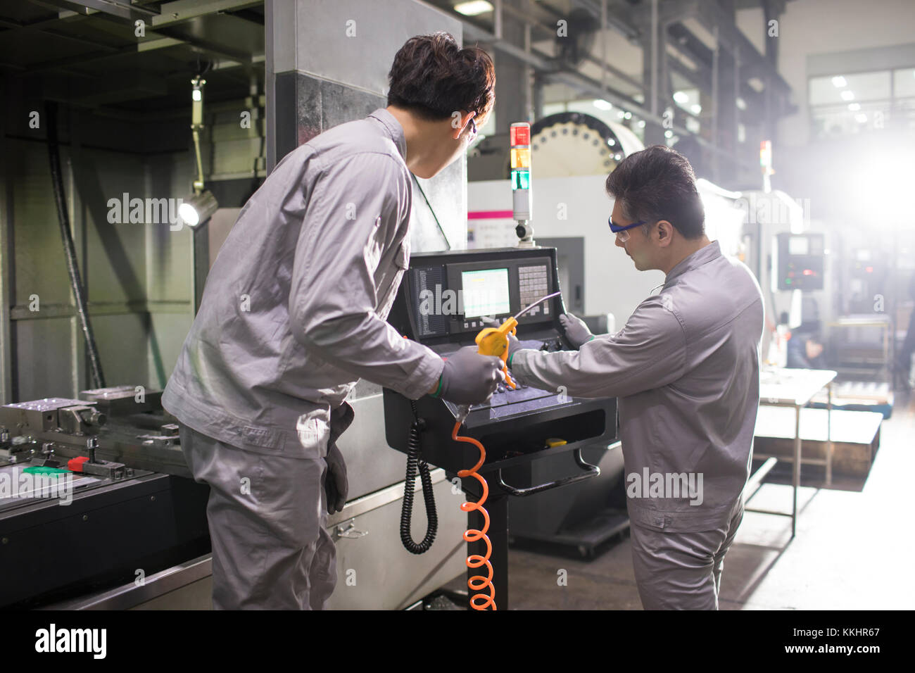 Confident Chinese engineers working in the factory Stock Photo - Alamy