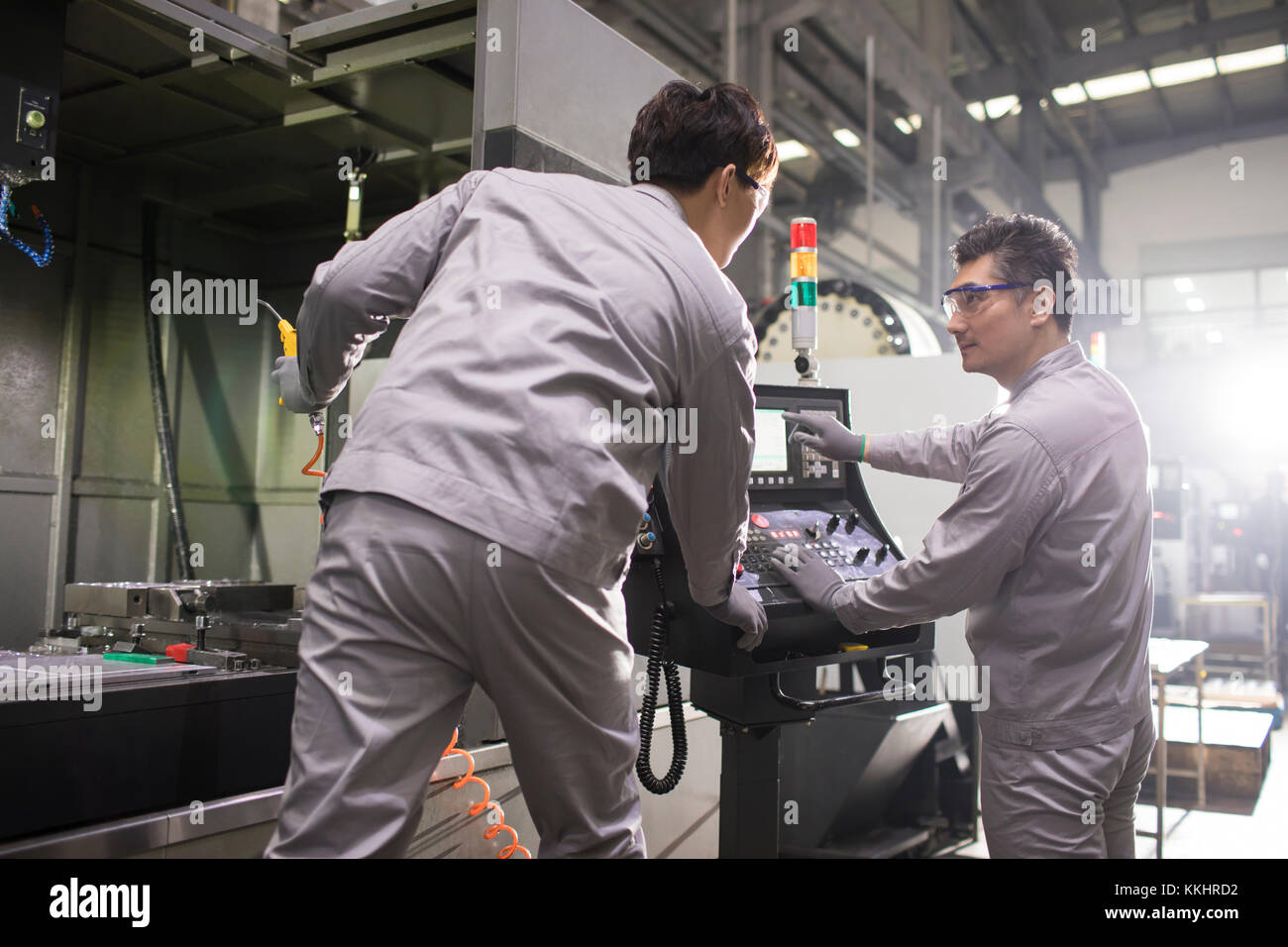 Confident Chinese engineers working in the factory Stock Photo - Alamy