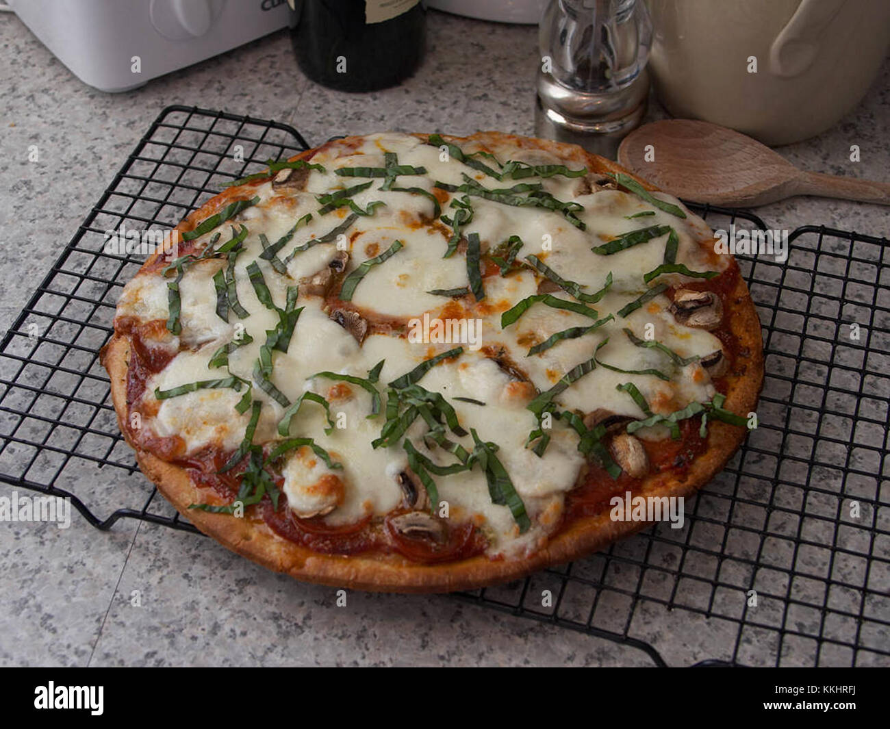 A photograph of pizza resting on a rack, highlighting the preparation ...