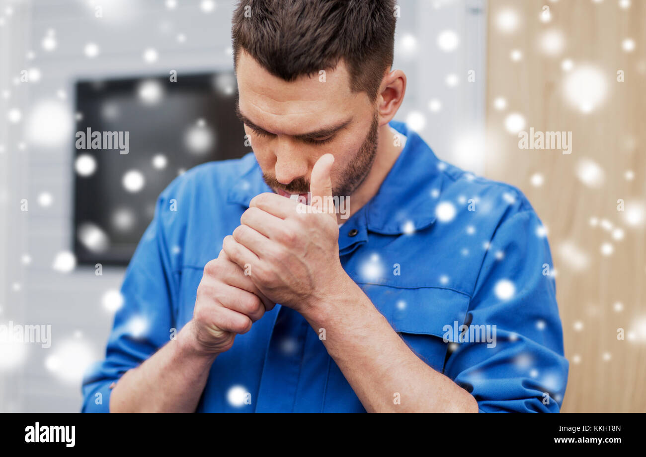 auto mechanic lighting up or smoking cigarette Stock Photo - Alamy