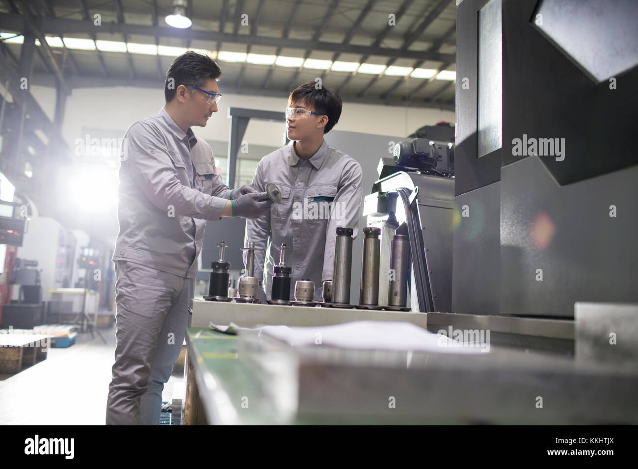 Confident Chinese engineers working in the factory Stock Photo - Alamy