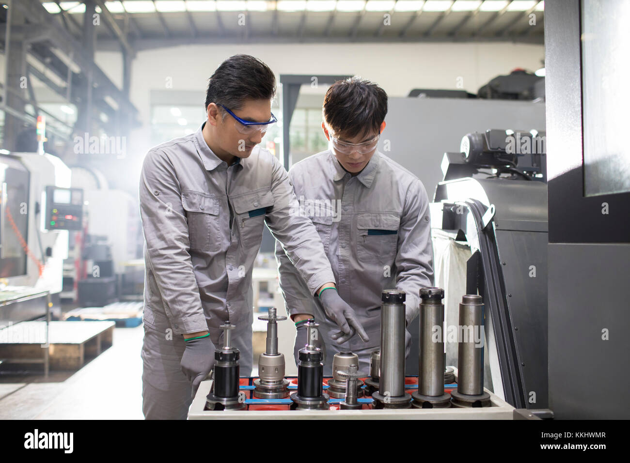 Confident Chinese engineers working in the factory Stock Photo - Alamy