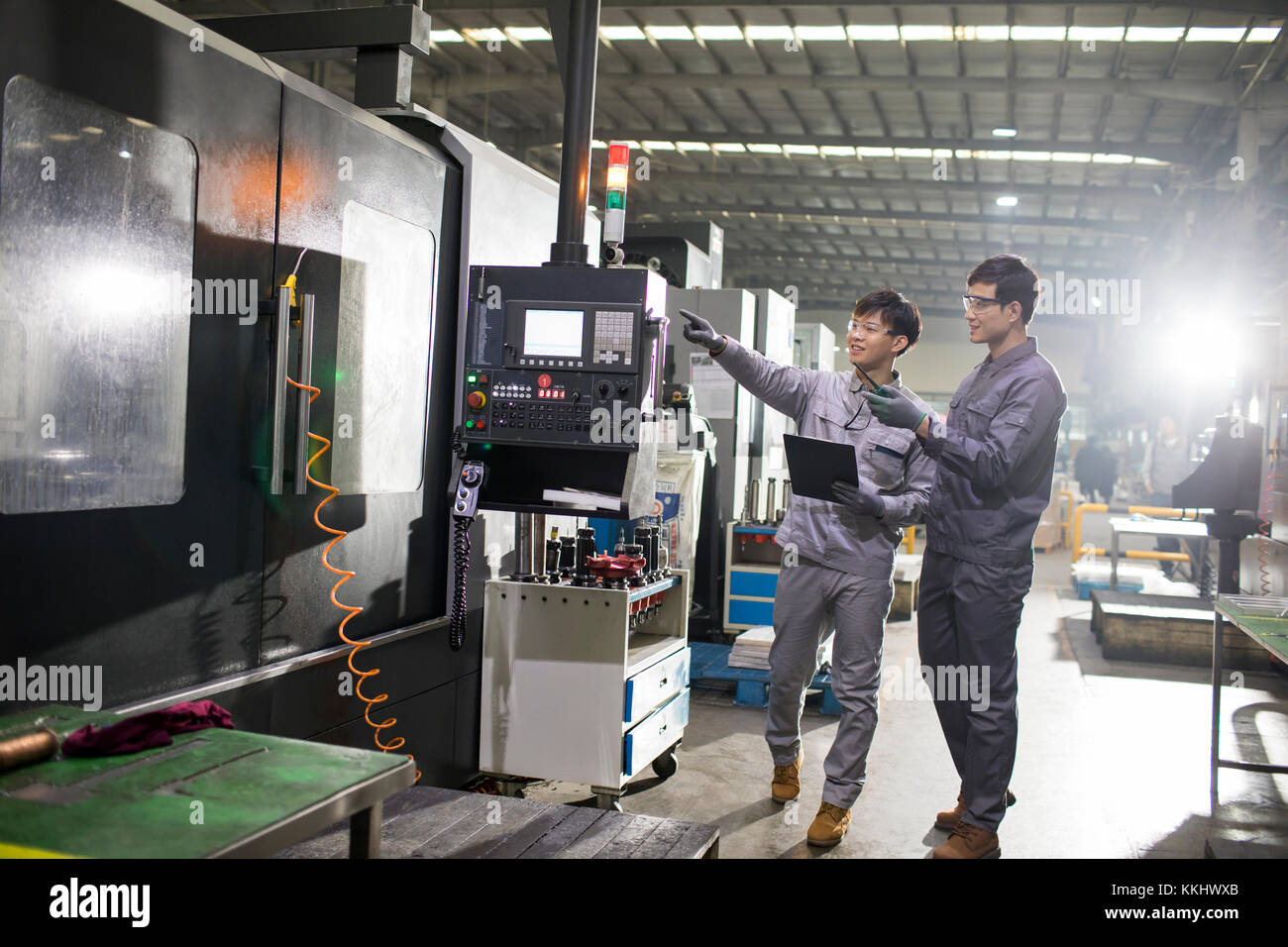 Confident Chinese engineers working in the factory Stock Photo - Alamy