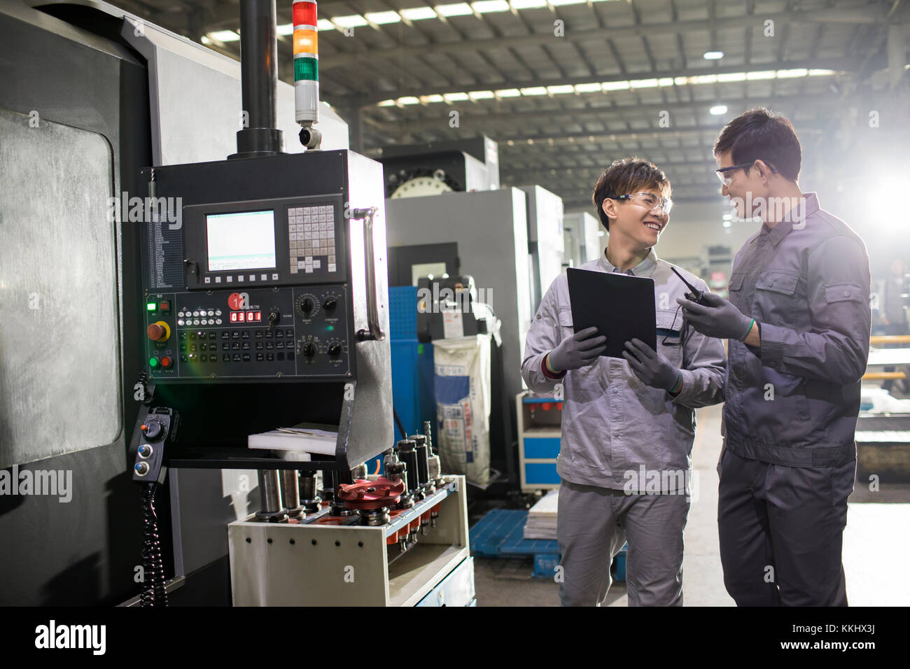 Confident Chinese engineers talking in the factory Stock Photo - Alamy
