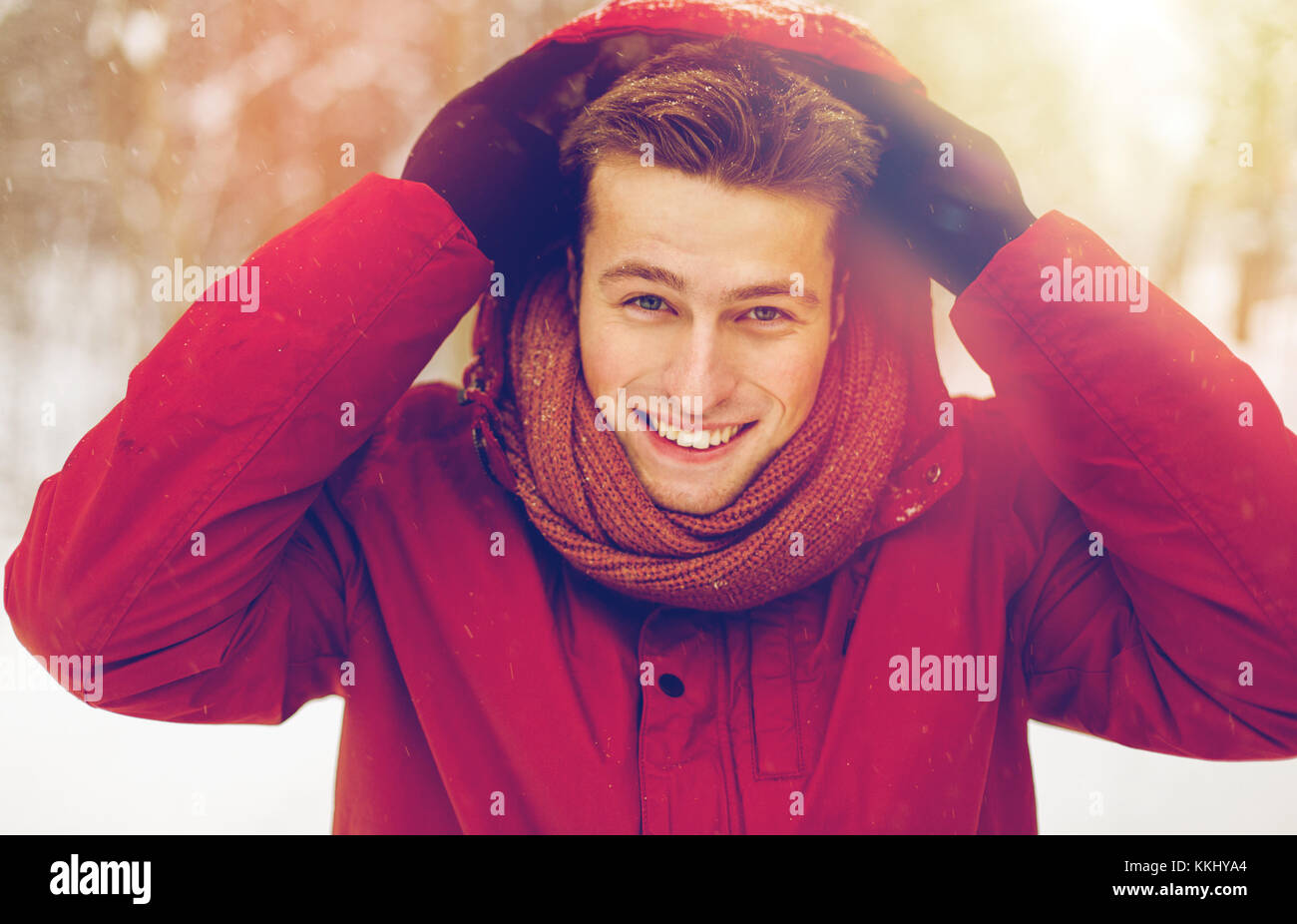 happy man in winter jacket with hood outdoors Stock Photo - Alamy