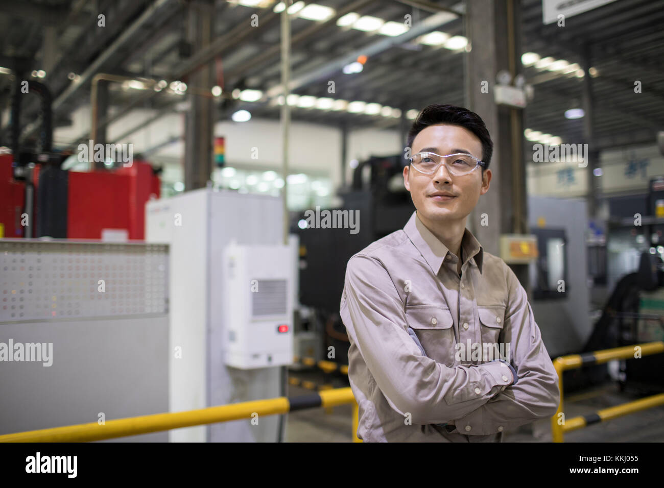 Confident Chinese engineer in the factory Stock Photo - Alamy