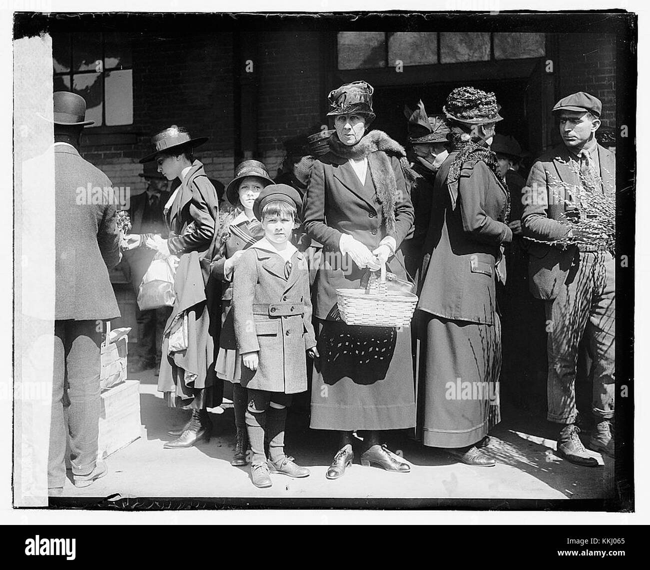 This image shows Mrs. Houston and her children in a market setting. The ...