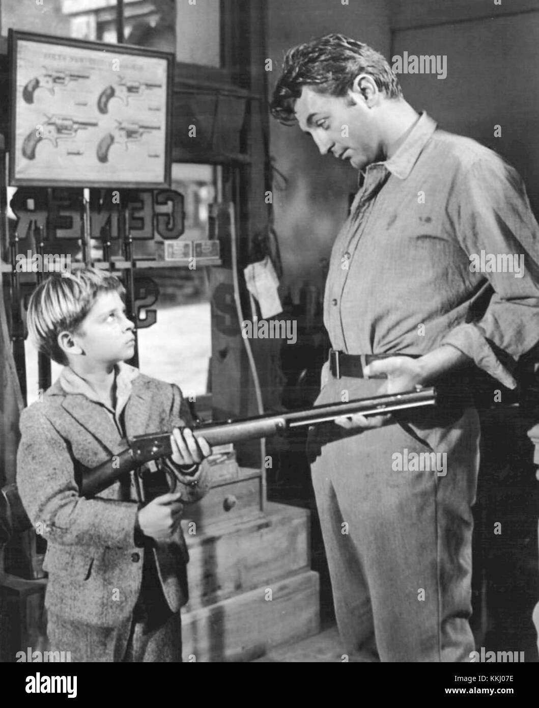 This 1954 image features actors Robert Mitchum and Tommy Rettig from ...
