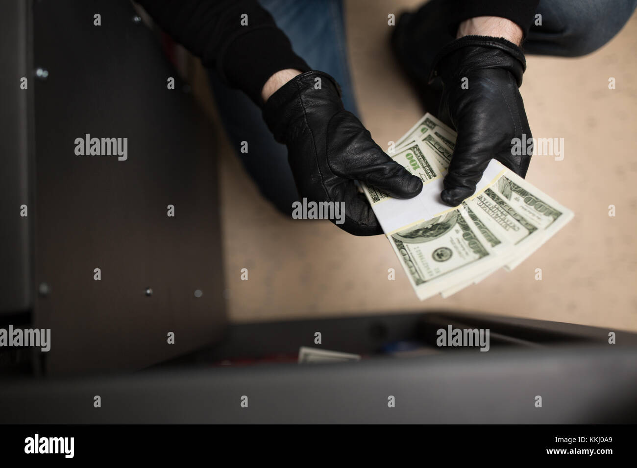 thief stealing money from safe at crime scene Stock Photo - Alamy