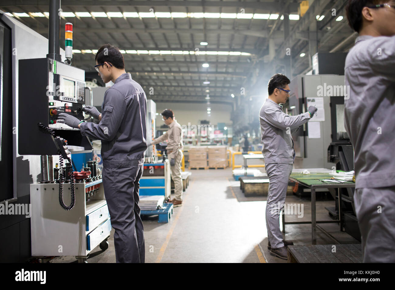 Confident Chinese engineers working in the factory Stock Photo - Alamy