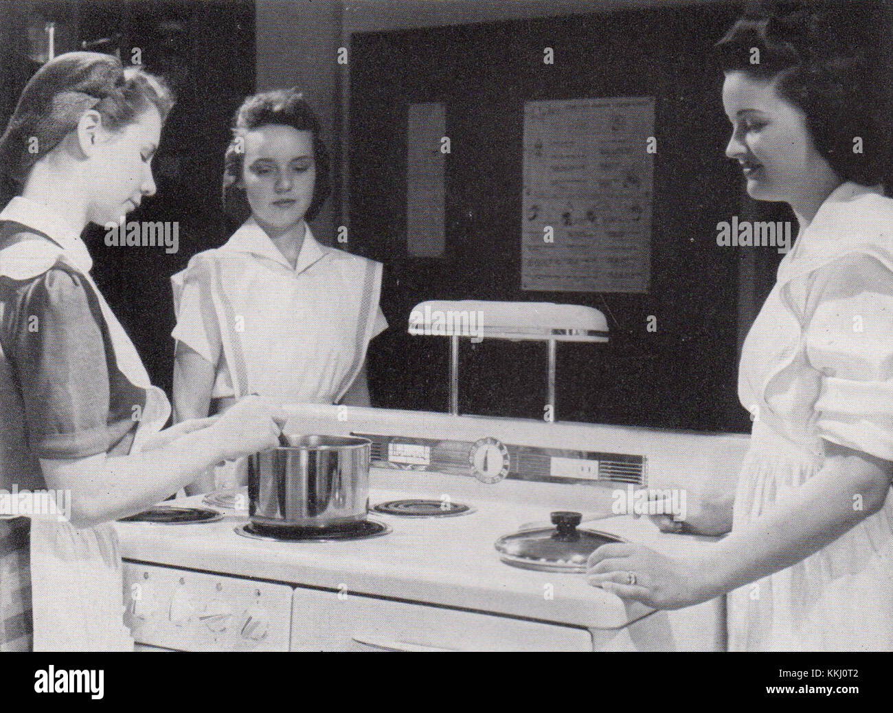 A photograph depicting students engaged in home economics cooking ...
