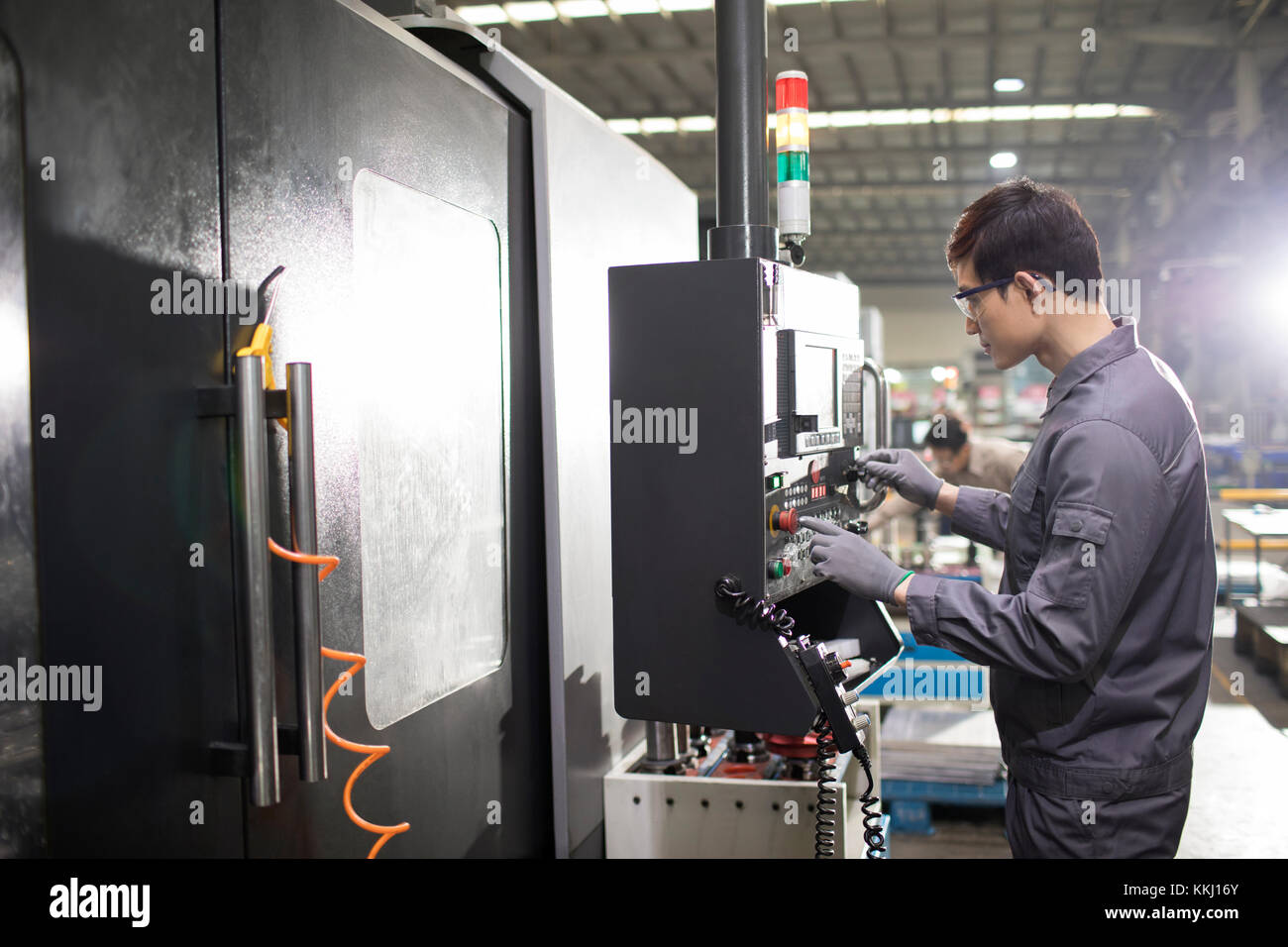 Confident Chinese engineer working in the factory Stock Photo - Alamy