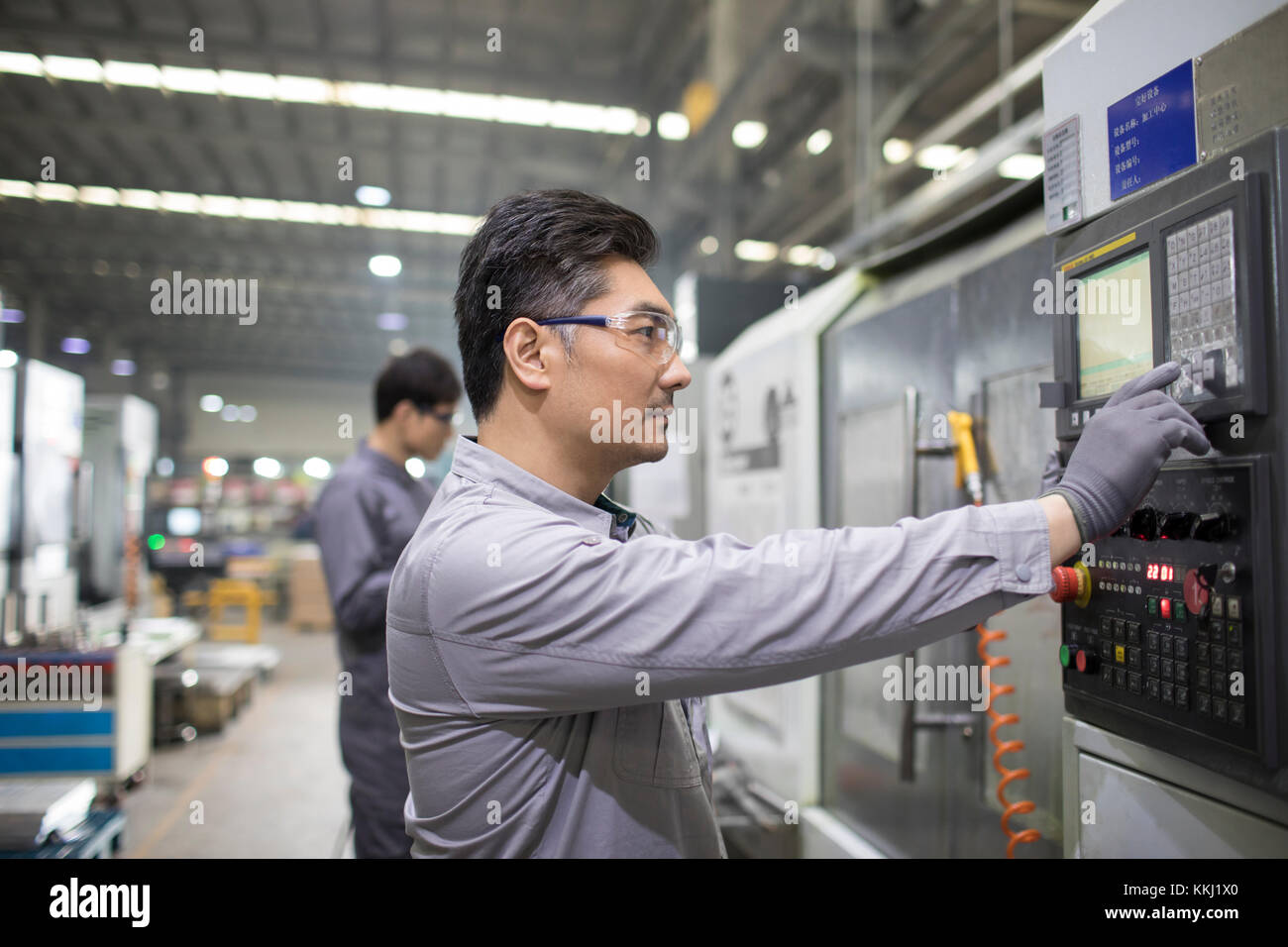 Confident Chinese engineers working in the factory Stock Photo - Alamy