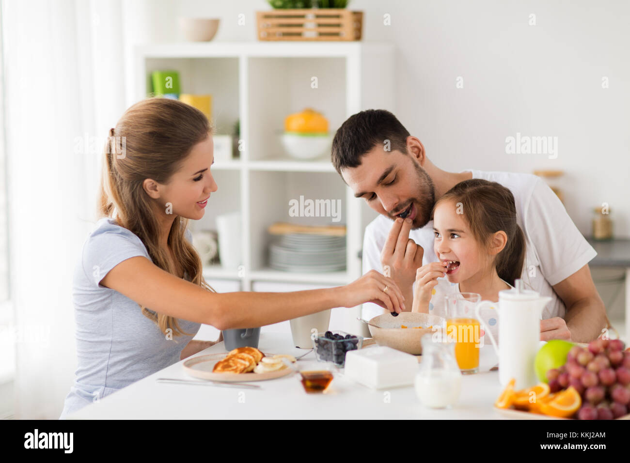 happy family having breakfast at home Stock Photo - Alamy