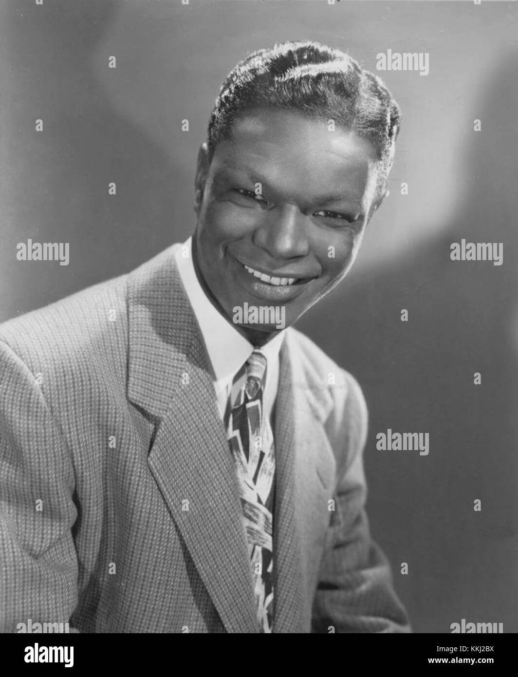 Nat King Cole, an iconic American jazz and pop singer, is captured in a ...
