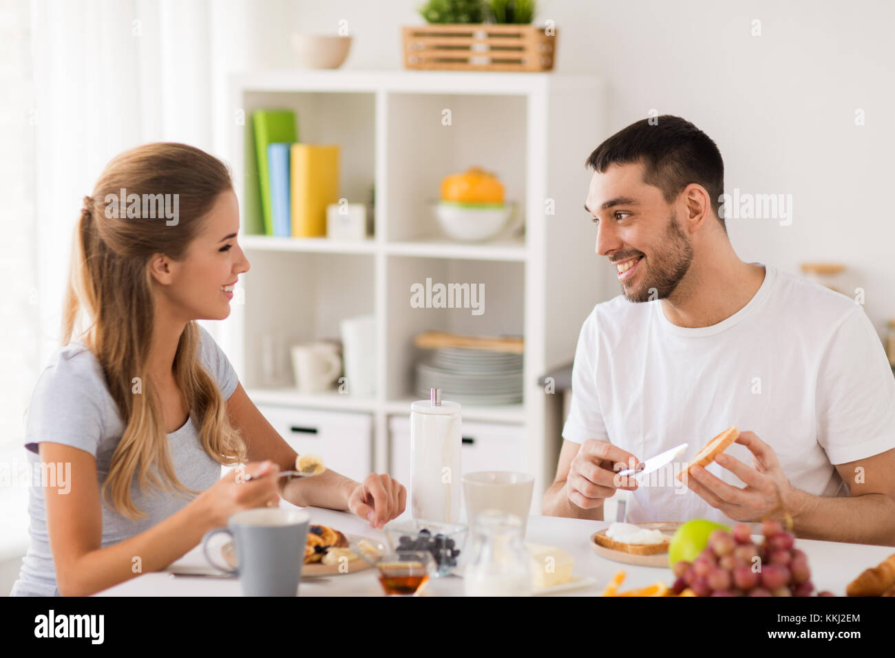 happy couple having breakfast at home Stock Photo - Alamy