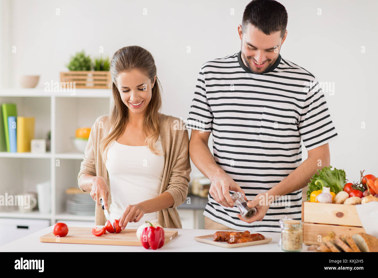 happy couple cooking food at home kitchen Stock Photo - Alamy