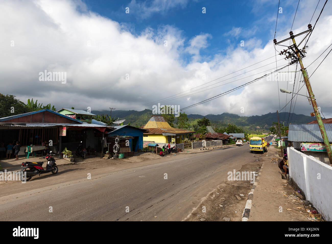 MONI, INDONESIA - MAY 13: The Main road that runs through small village ...
