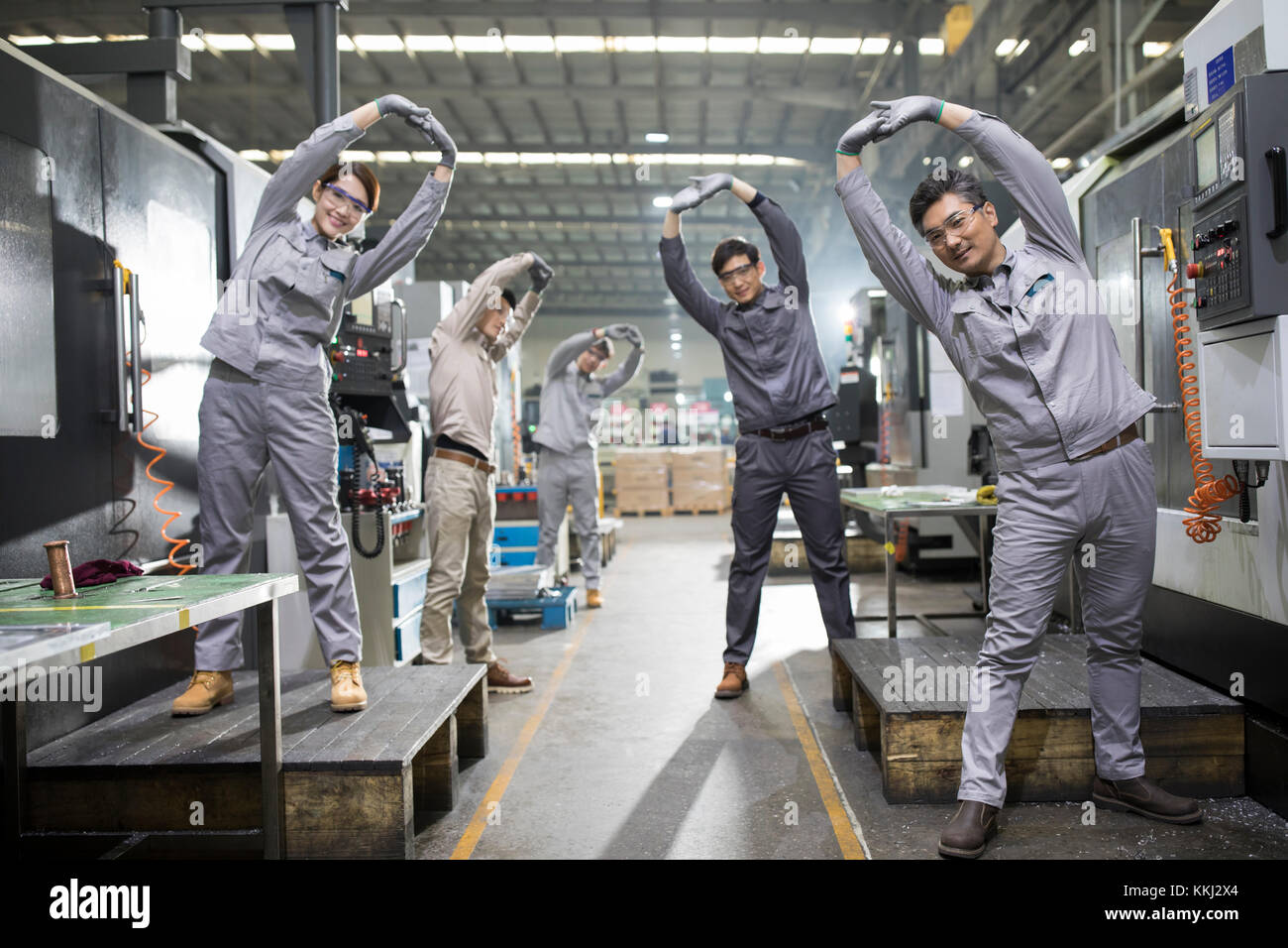 Chinese engineers stretching in the factory Stock Photo - Alamy