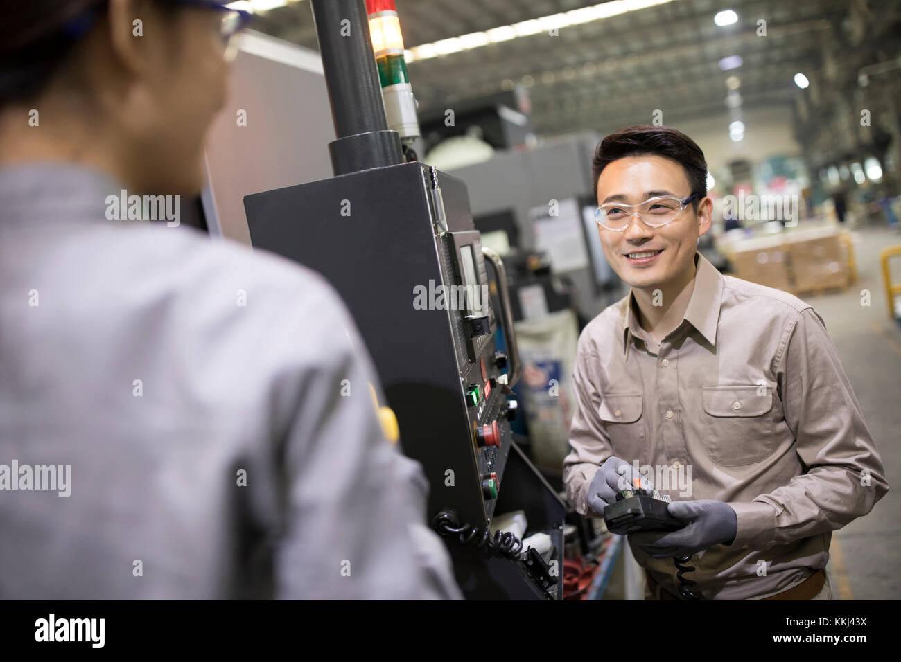 Confident Chinese engineers talking in the factory Stock Photo - Alamy
