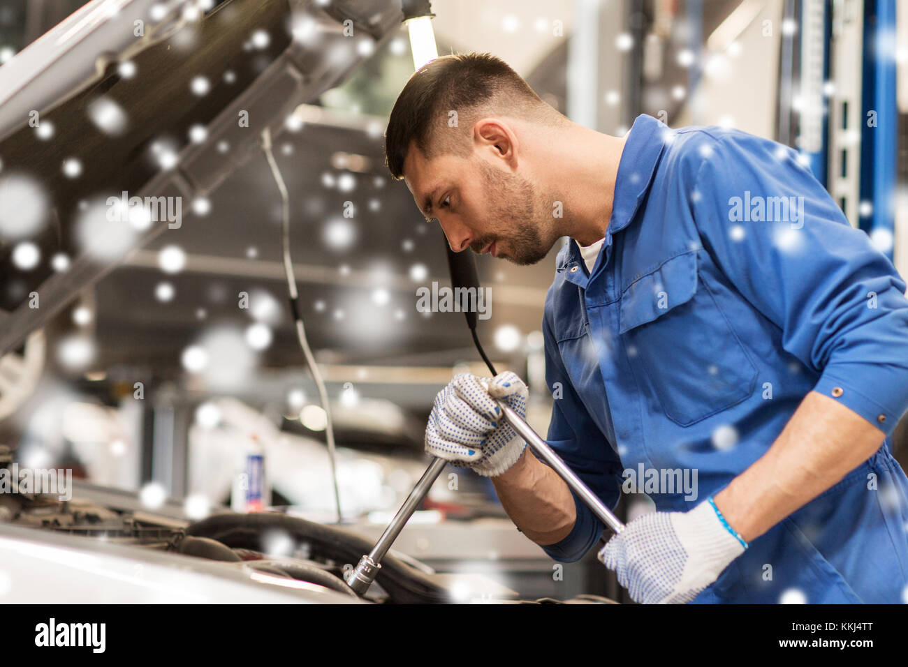mechanic man with wrench repairing car at workshop Stock Photo - Alamy