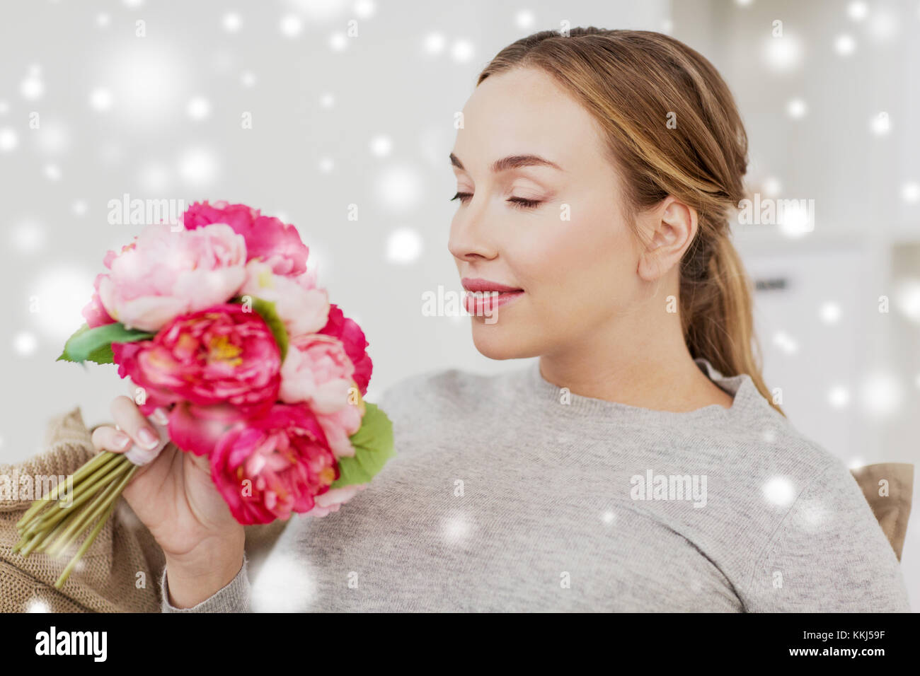 happy woman smelling flowers at home Stock Photo - Alamy