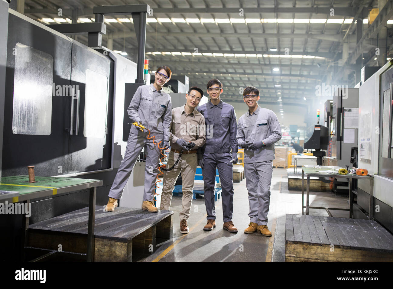 Confident Chinese engineers in the factory Stock Photo - Alamy