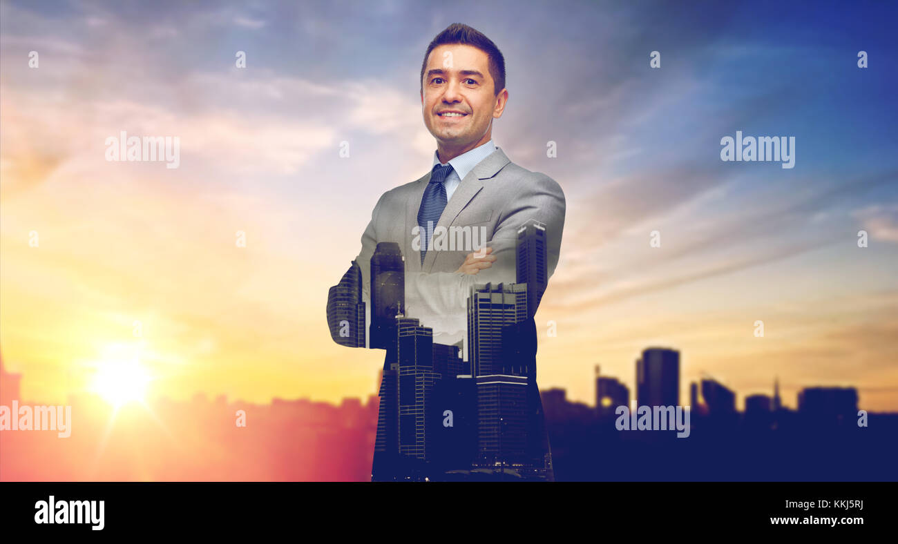 happy smiling businessman over city background Stock Photo - Alamy