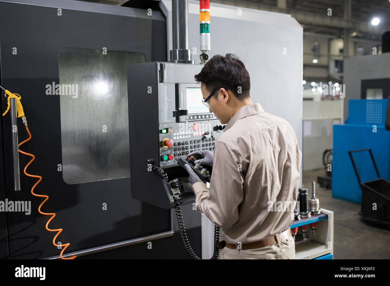 Male Chinese engineer working in the factory Stock Photo - Alamy