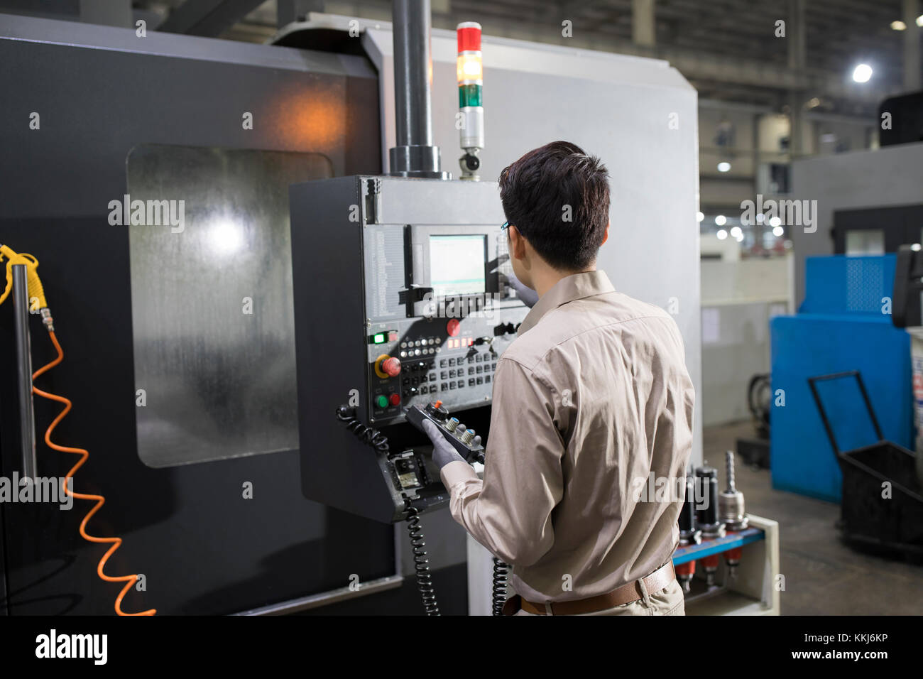 Male Chinese engineer working in the factory Stock Photo - Alamy
