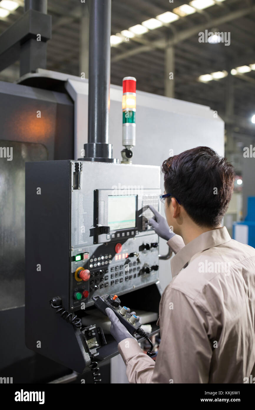Male Chinese engineer working in the factory Stock Photo - Alamy