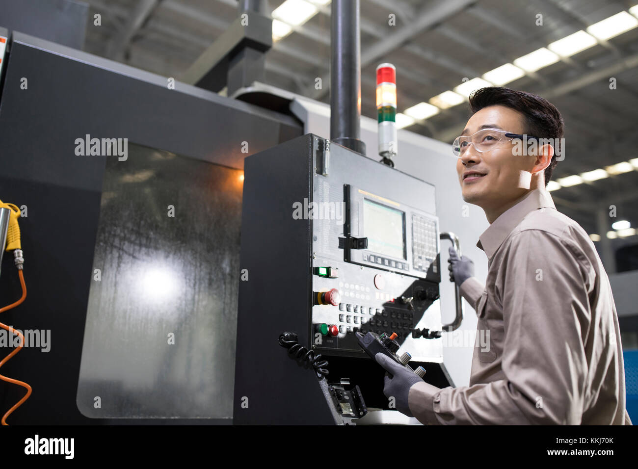 Confident Chinese engineer working in the factory Stock Photo - Alamy