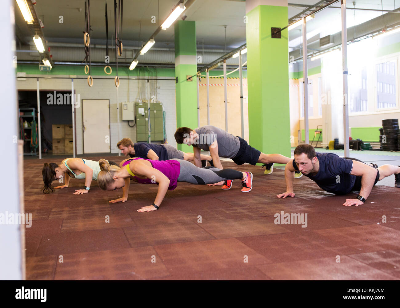 group of people doing push-ups in gym Stock Photo - Alamy