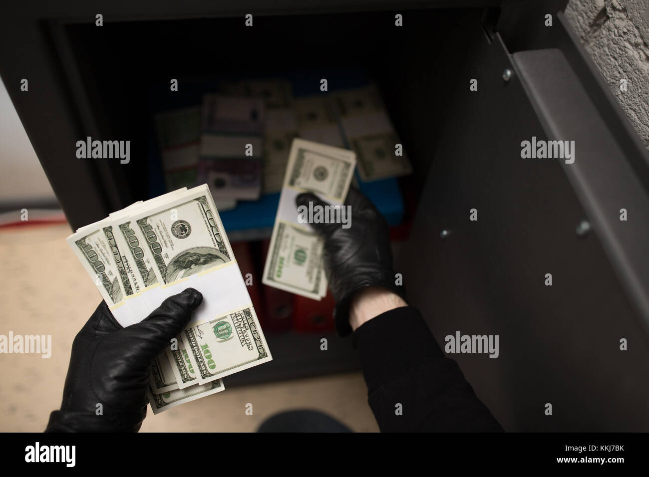thief stealing money from safe at crime scene Stock Photo - Alamy