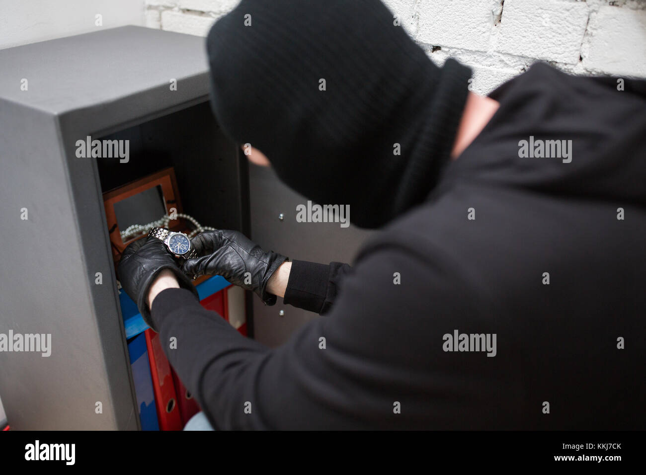 thief stealing valuables from safe at crime scene Stock Photo - Alamy