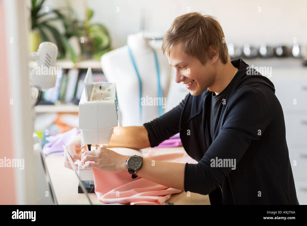 fashion designer with sewing machine working Stock Photo - Alamy
