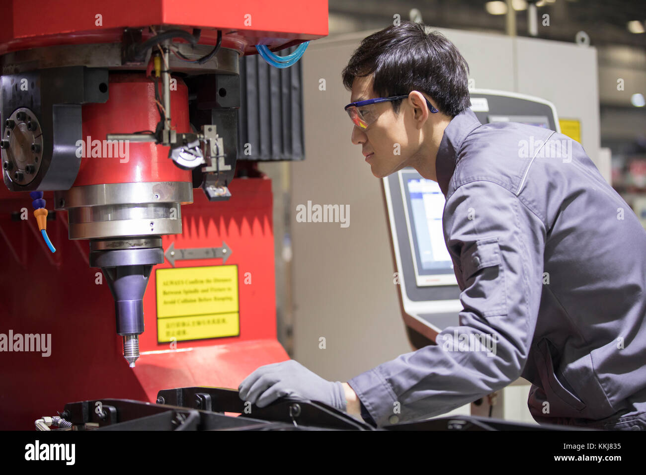 Confident Chinese engineer working in the factory Stock Photo - Alamy