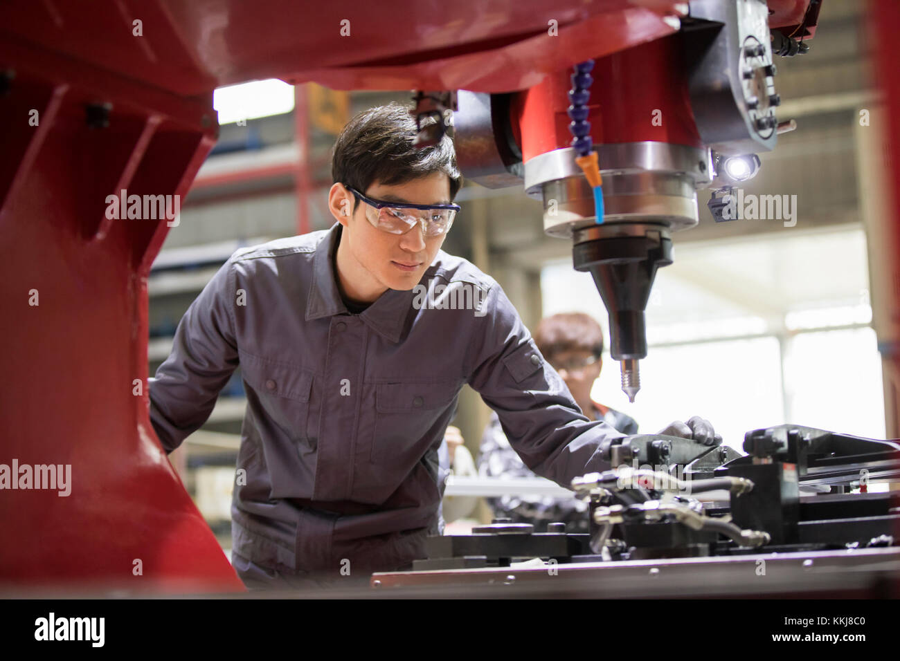 Confident Chinese engineer working in the factory Stock Photo - Alamy