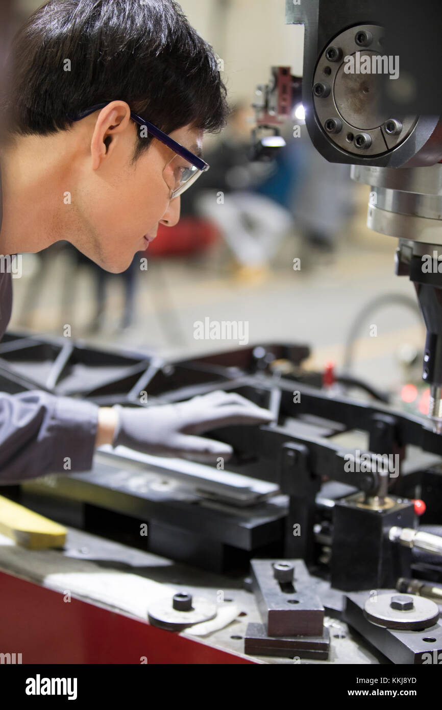 Confident Chinese engineer working in the factory Stock Photo - Alamy