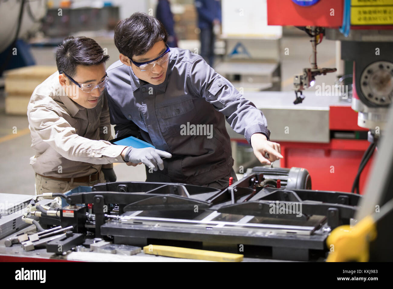 Confident Chinese engineers working in the factory Stock Photo - Alamy