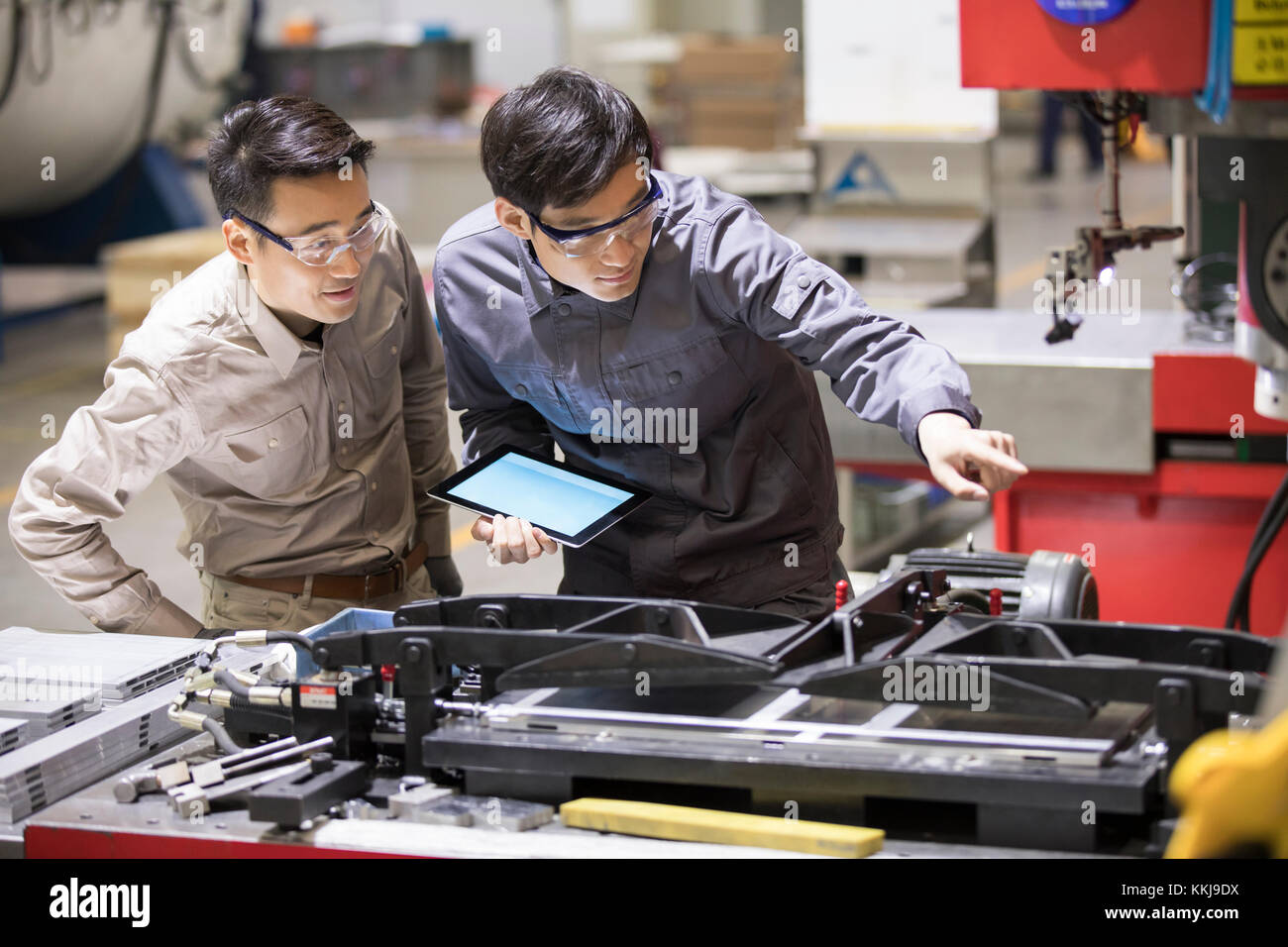 Confident Chinese engineers talking in the factory Stock Photo - Alamy