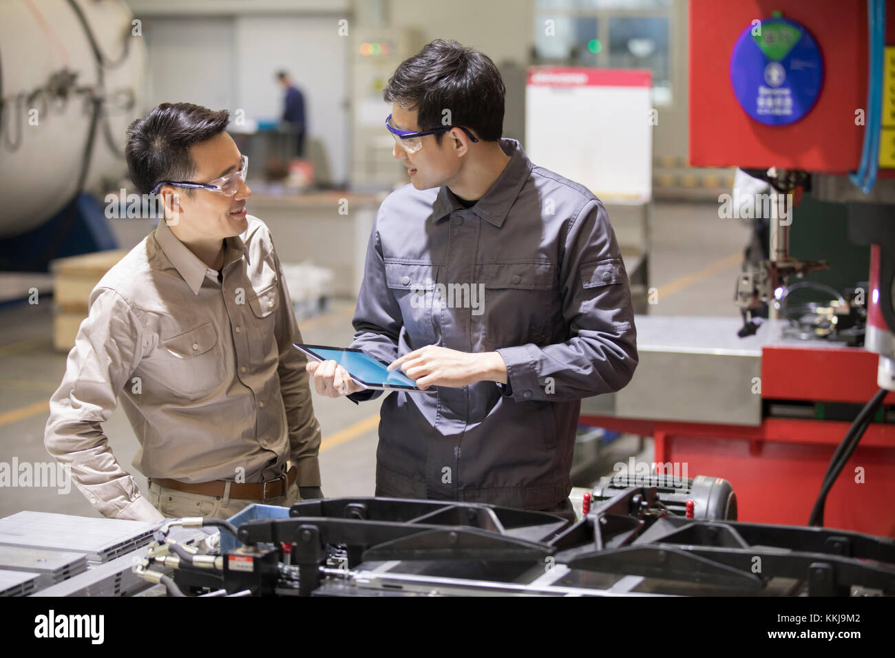 Confident Chinese engineers talking in the factory Stock Photo - Alamy
