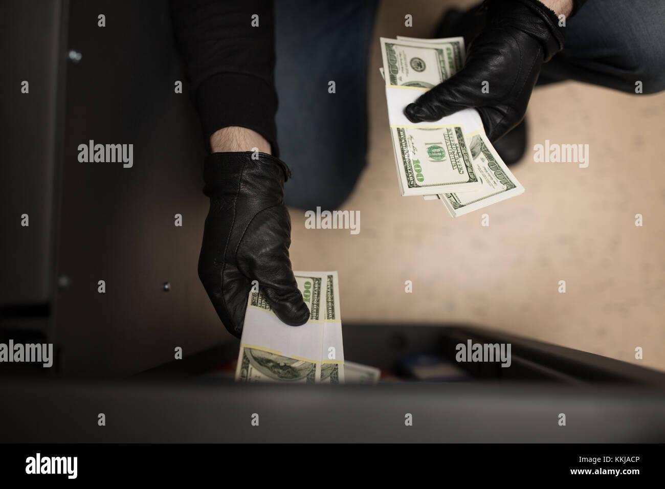 thief stealing money from safe at crime scene Stock Photo - Alamy